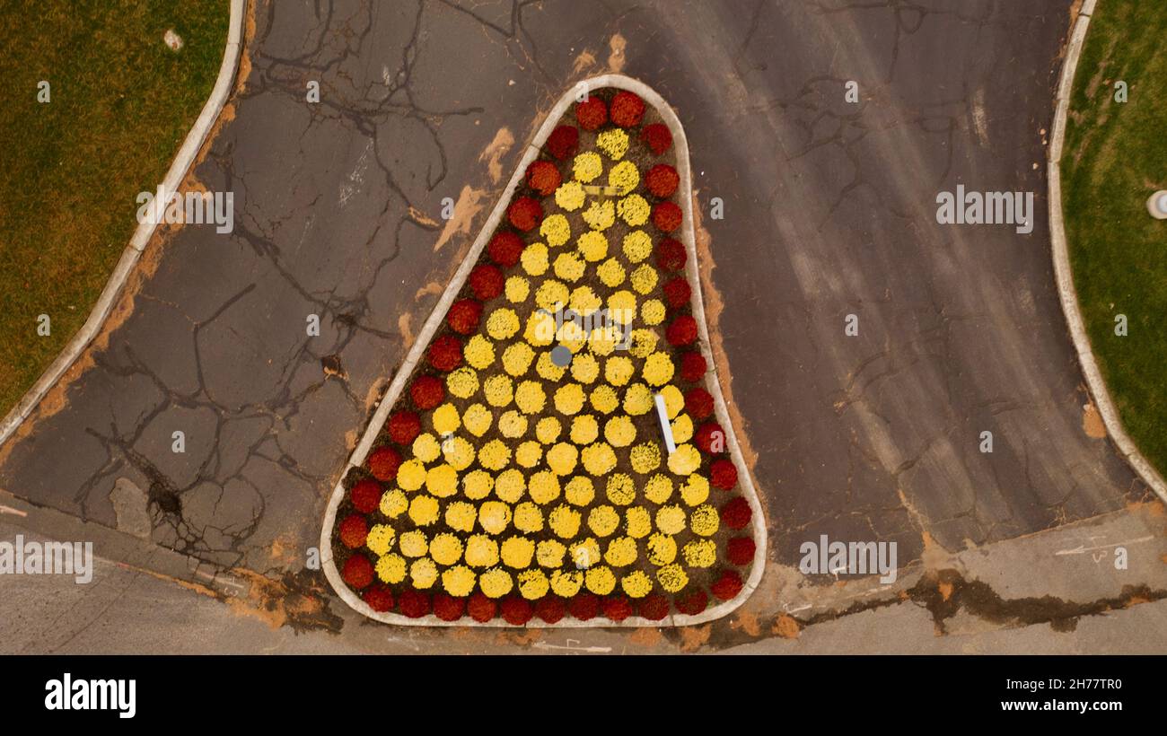 An aerial shot of a floral road median in a parking lot entrance in the ...