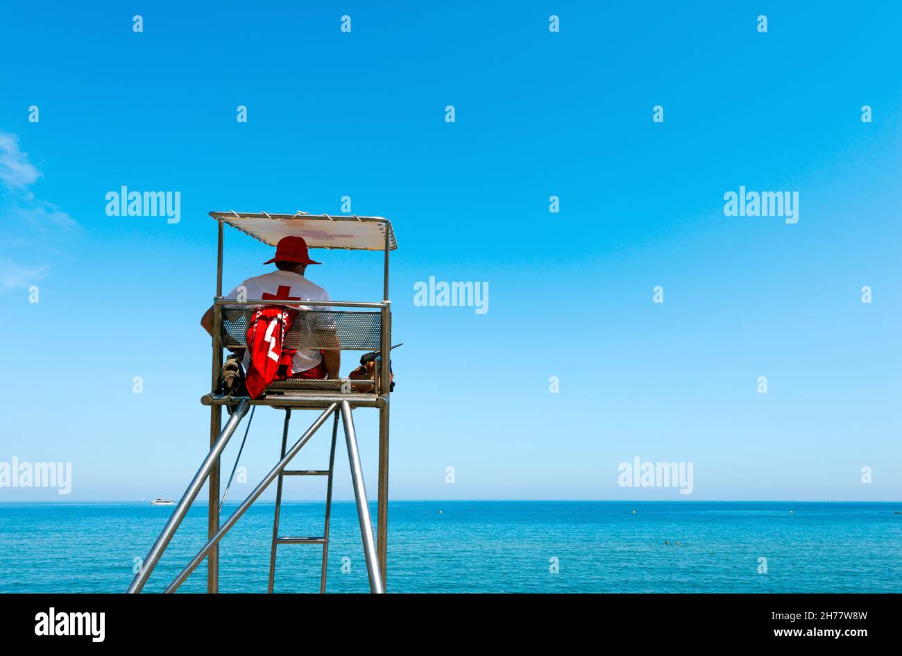 Lifeguard on the watching tower check the people who swim in the sea ...