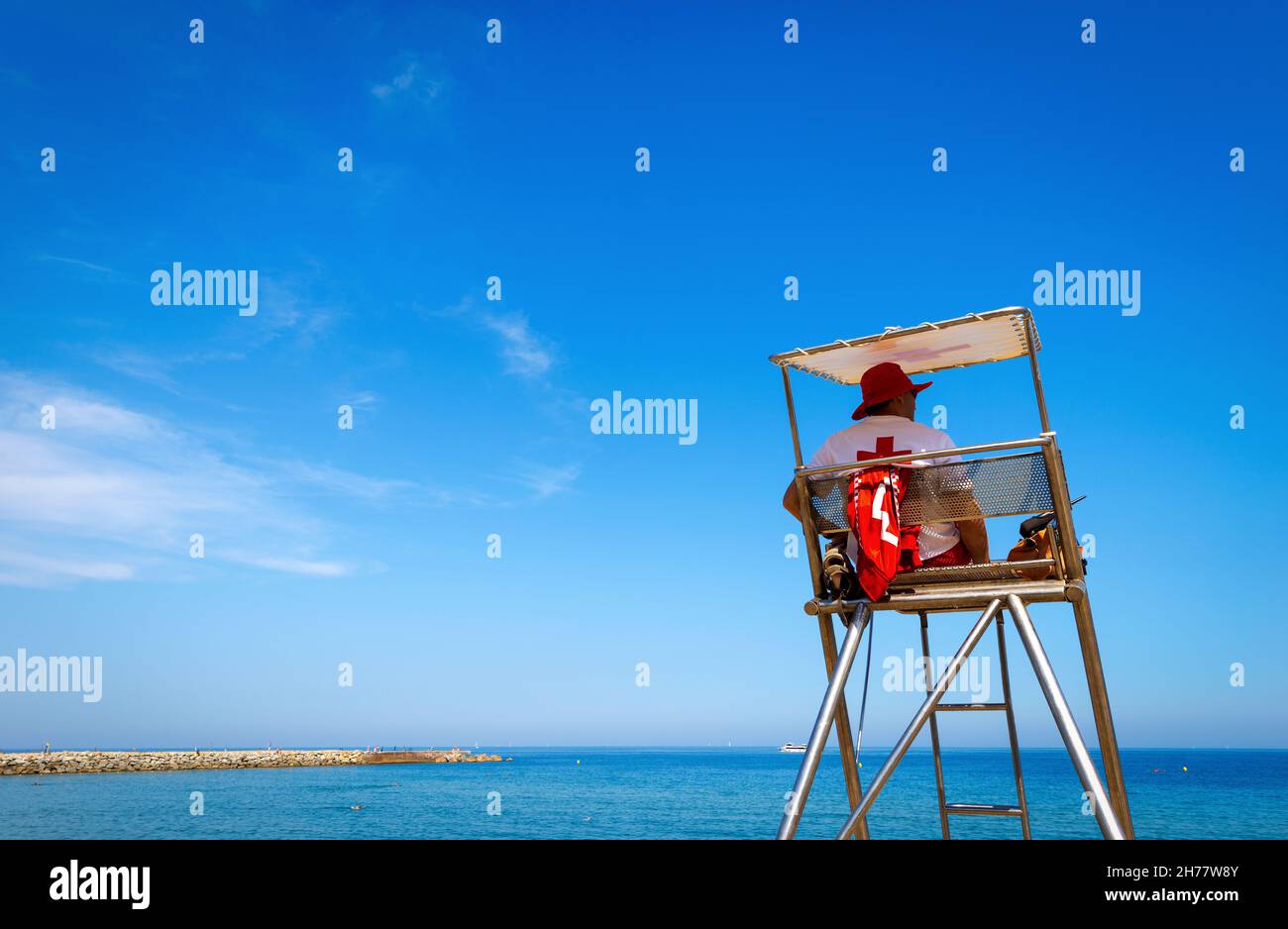 Lifeguard on the watching tower check the people who swim in the sea ...