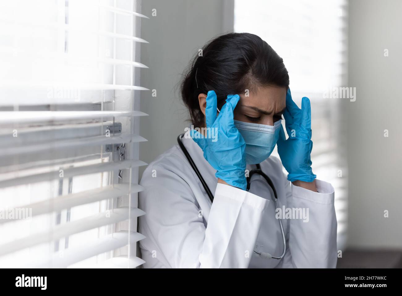 Close up tired Indian woman doctor in medical mask Stock Photo - Alamy