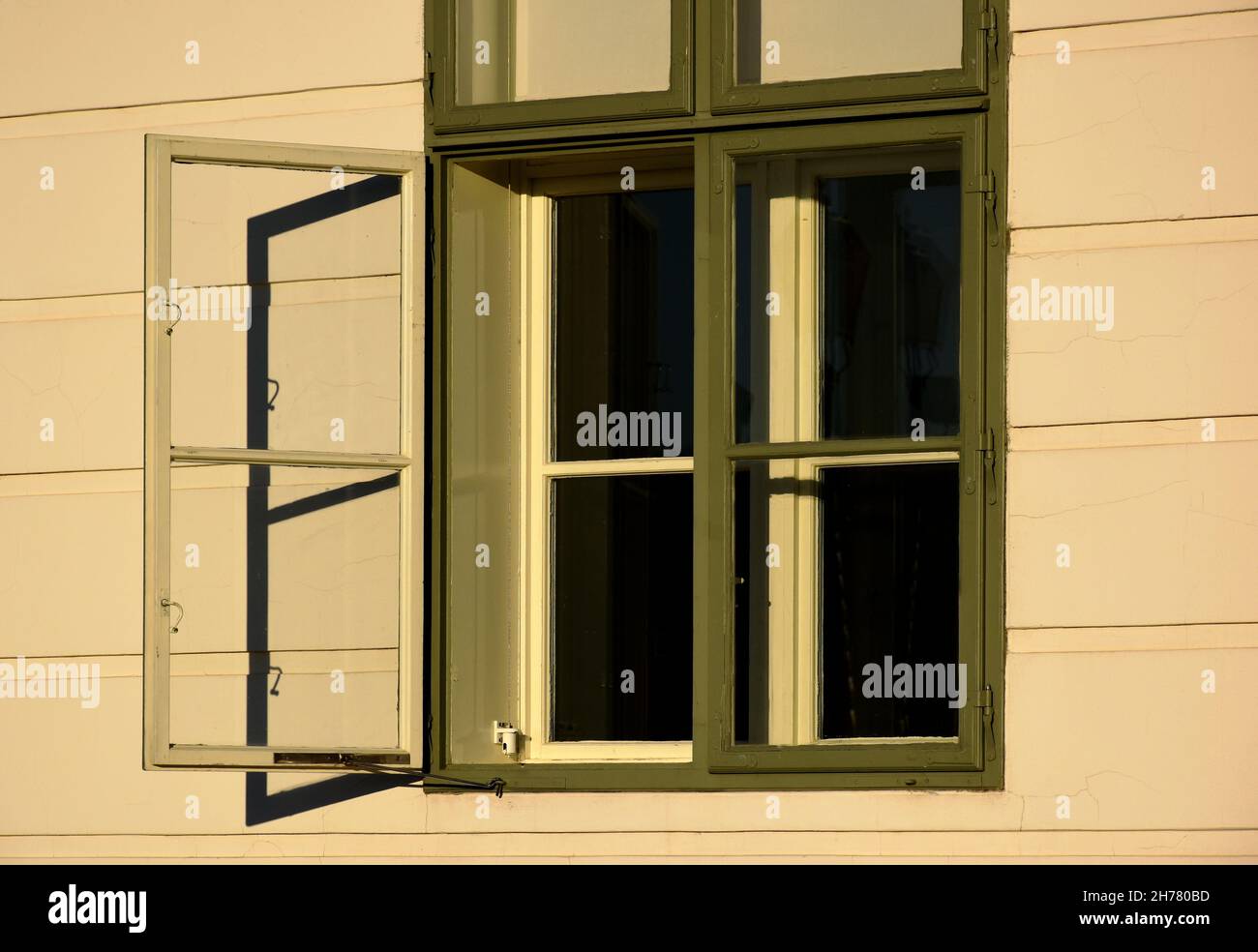 painted green wood window. beige stucco elevation. old classic ...