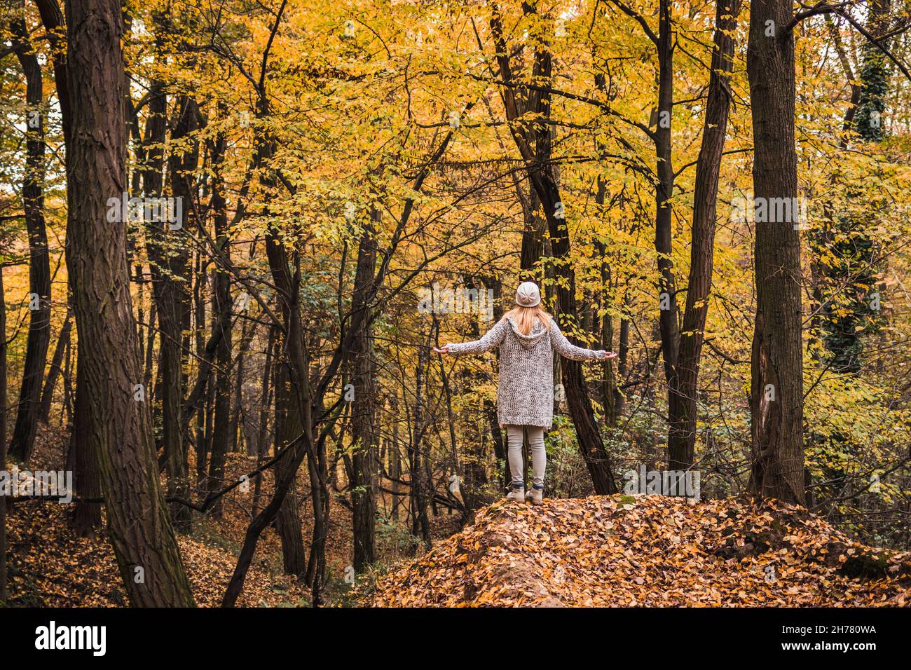 Woman enjoying fresh air and feeling positive energy in autumn forest ...