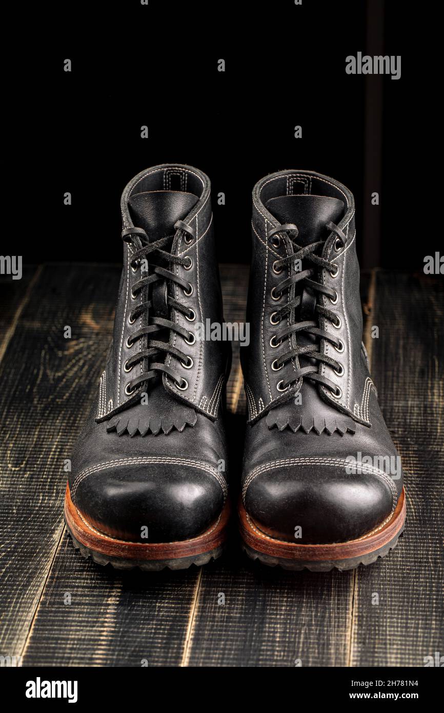 Hand crafted black leather high boots Stock Photo - Alamy