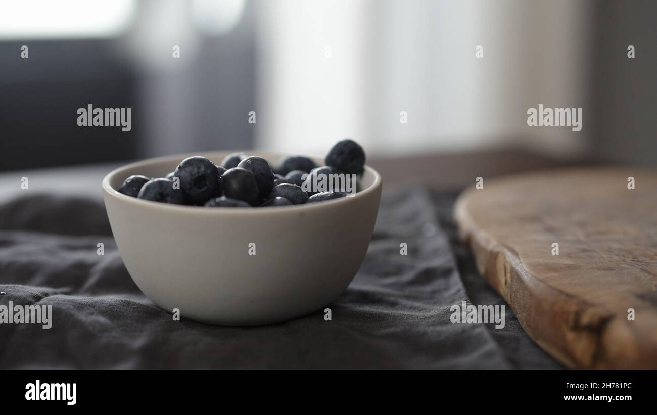 washed blueberries in white bowl on table wide photo Stock Photo - Alamy