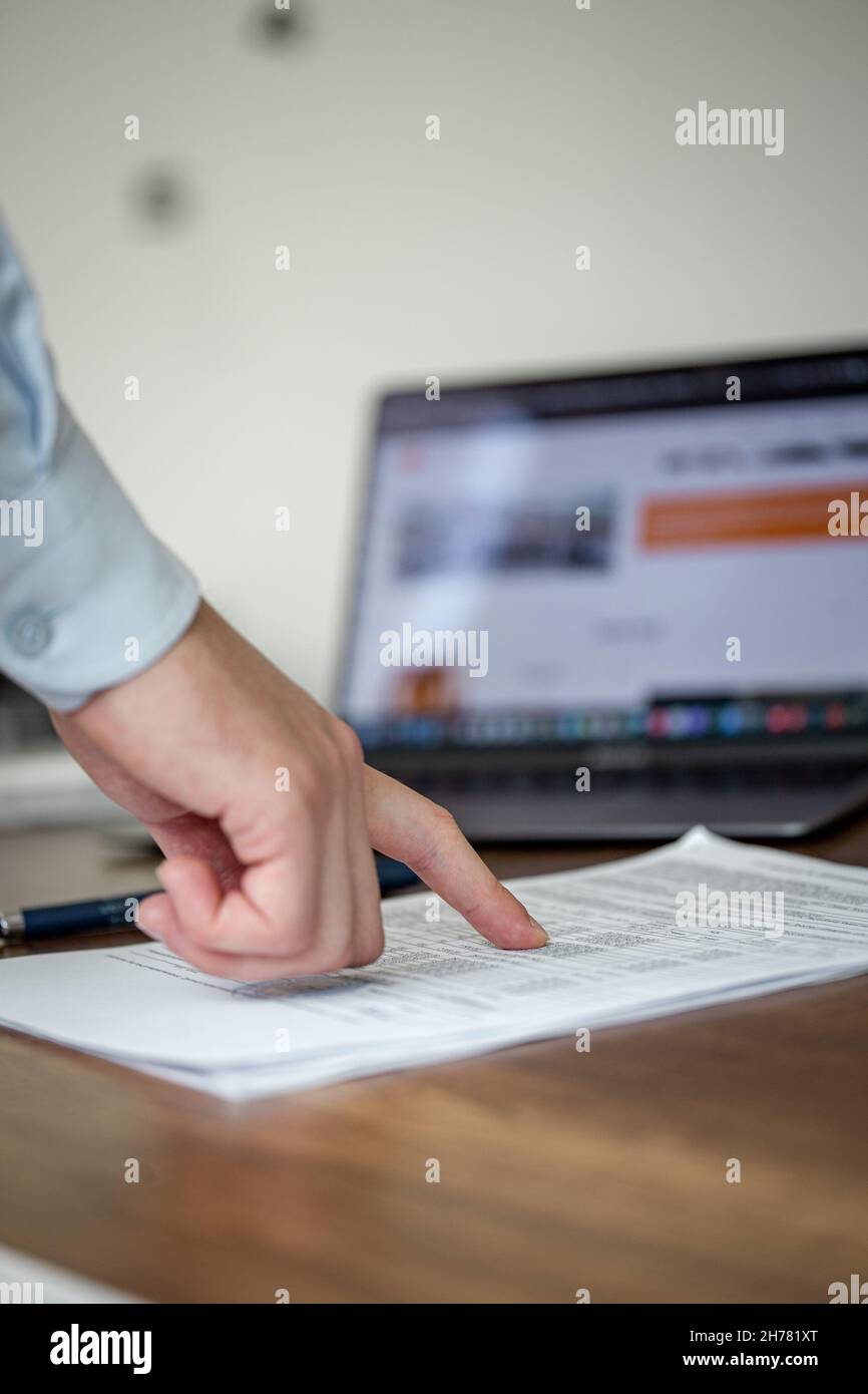 a man checks documents with his finger Stock Photo - Alamy