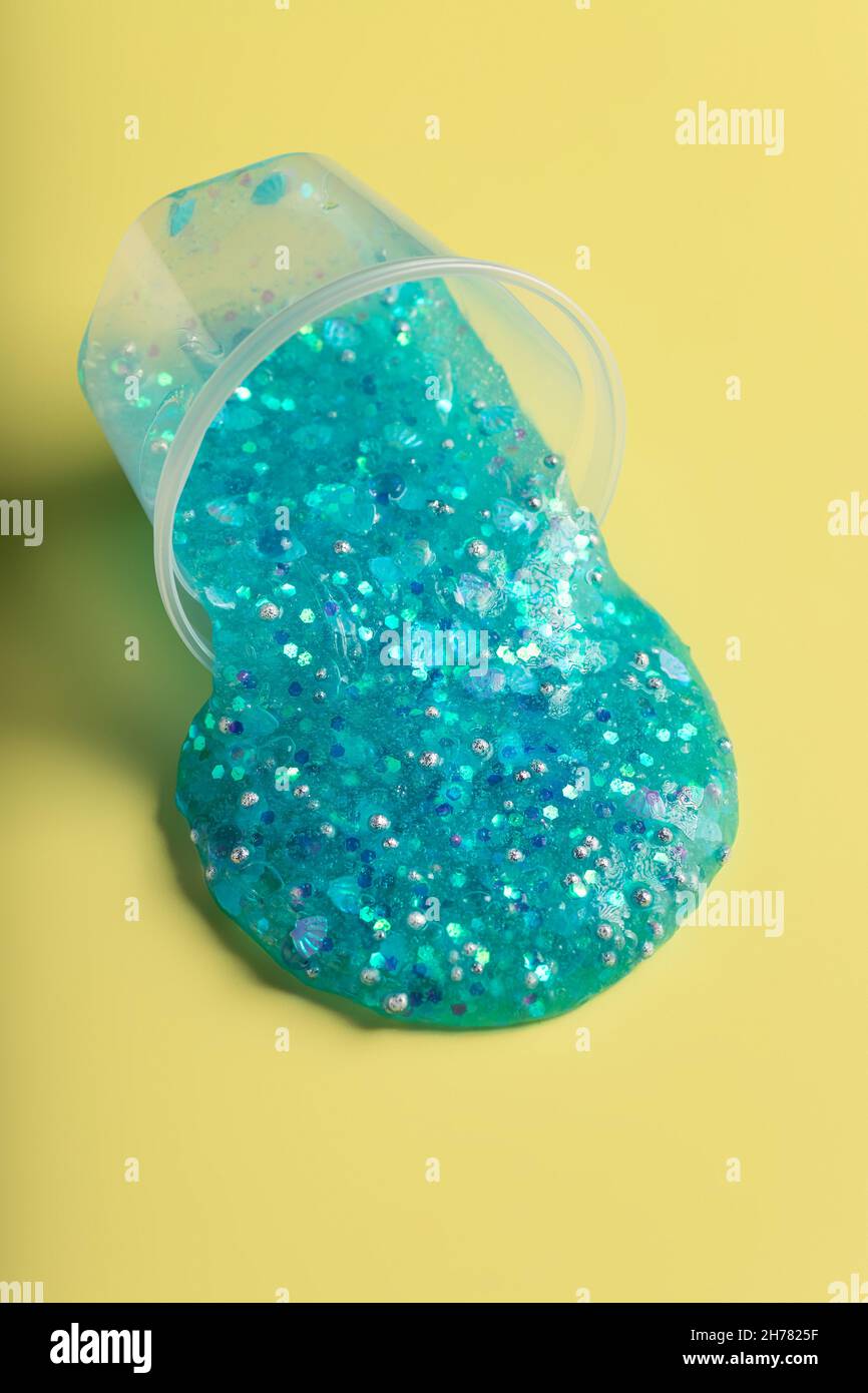 overturned plastic container with blue slime Stock Photo - Alamy
