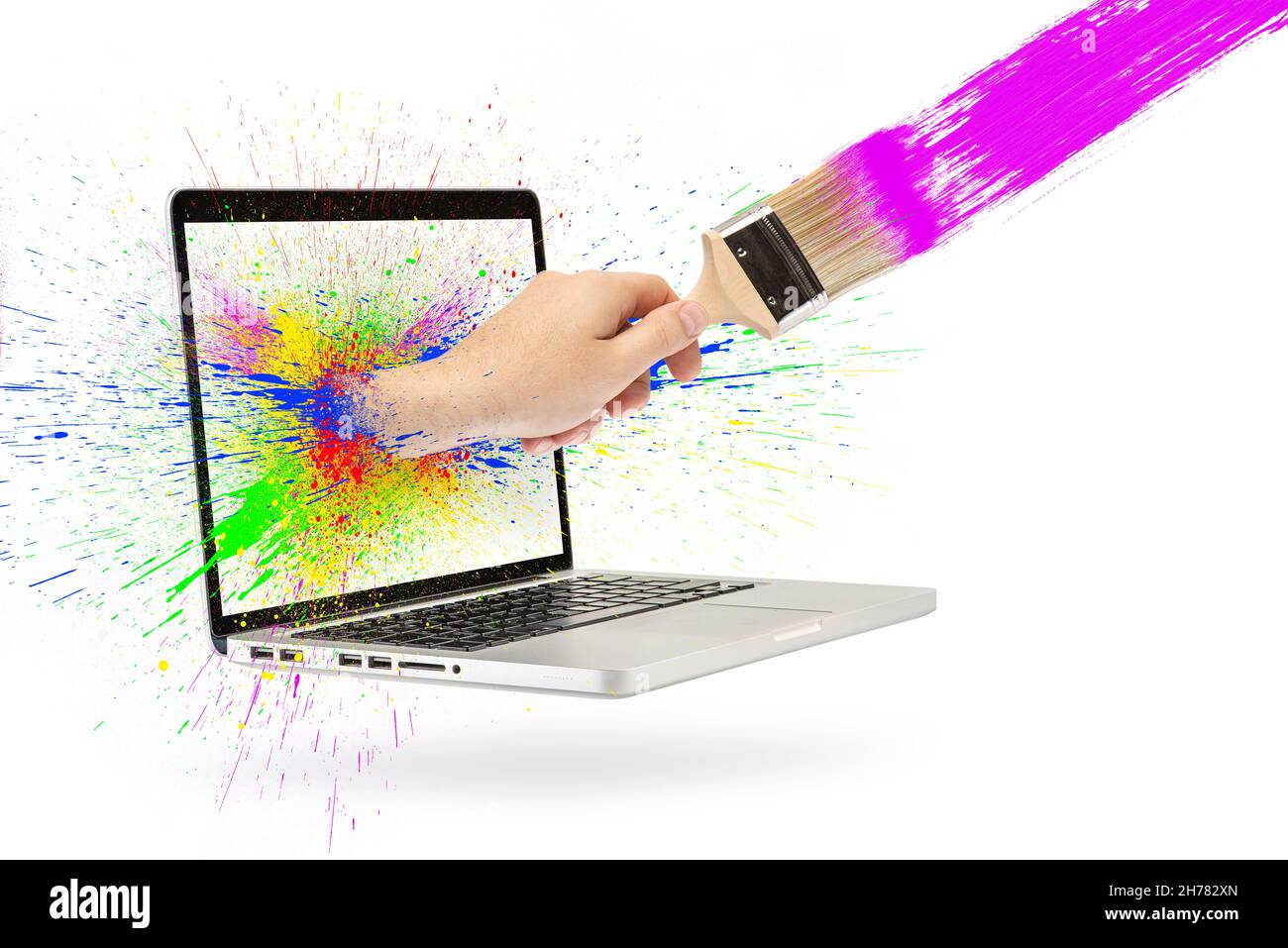 A hand with a paintbrush sticks out of the laptop screen. Isolated on ...
