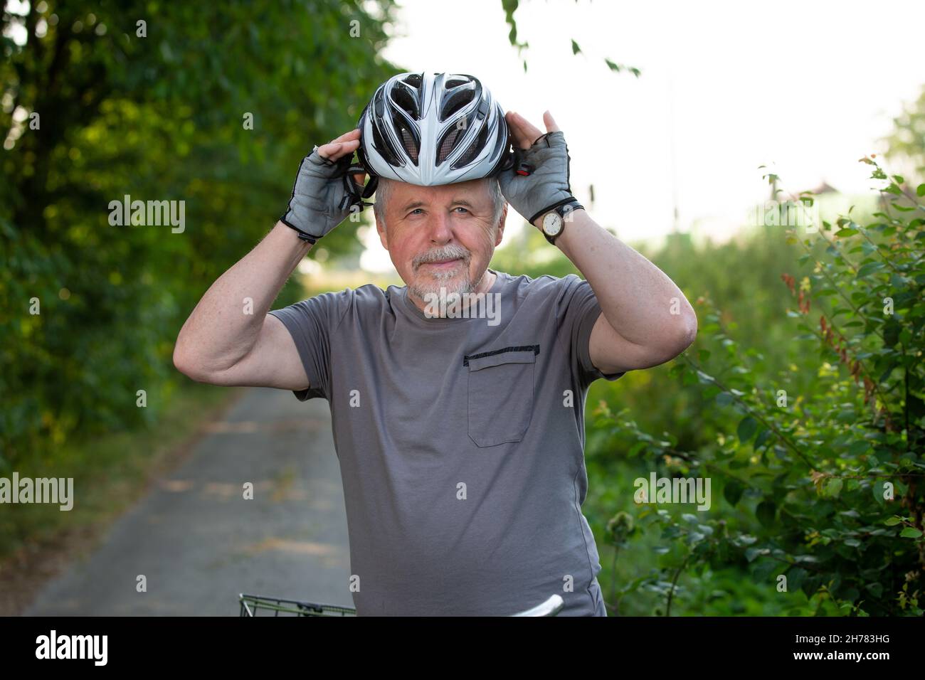 Elderly man riding bicycle bike ride exercise park cycle hi-res stock ...