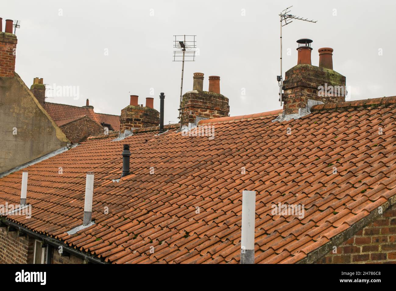 Roof tiles and chimneys of British terraced houses in York England ...