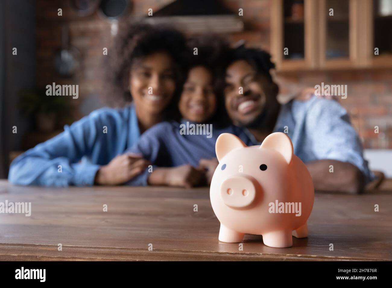 Happy African American family saving money for future Stock Photo - Alamy