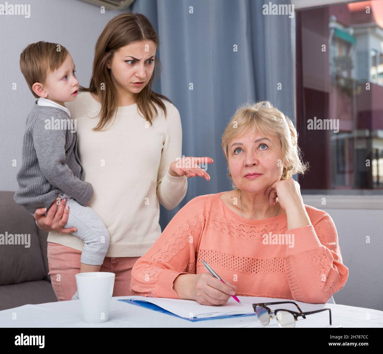 Adult female with her mother are having disagreements for problems with ...