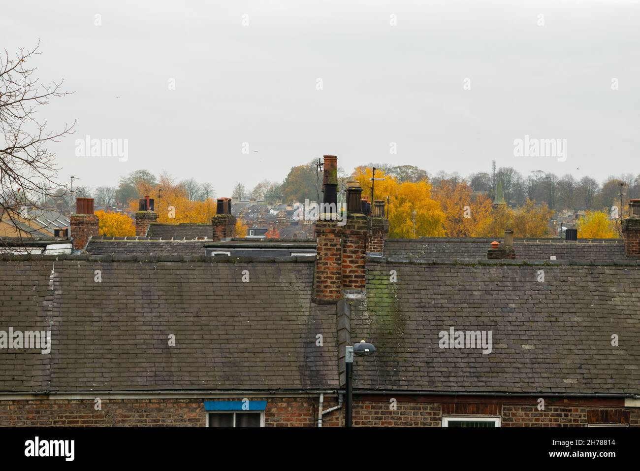 Roofs and chimneys of traditional British terraced brick houses in York ...