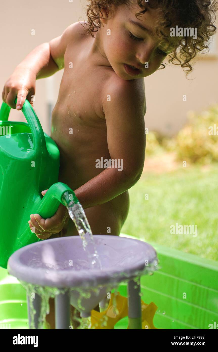 Toddler of three plays with water Stock Photo - Alamy