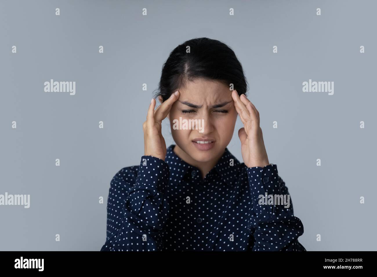 Stressed young Indian ethnicity woman suffering from headache Stock ...