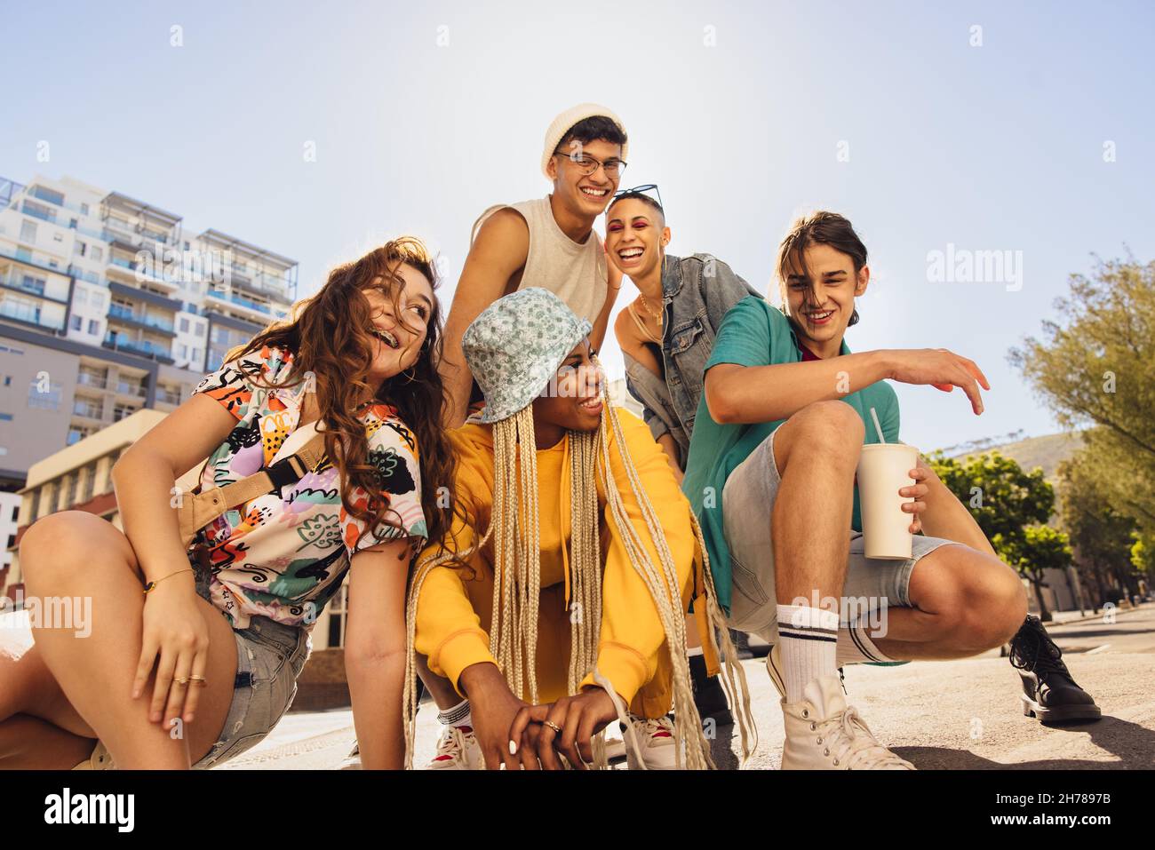 Smiling friends having fun outdoors. Group of multiethnic generation z ...