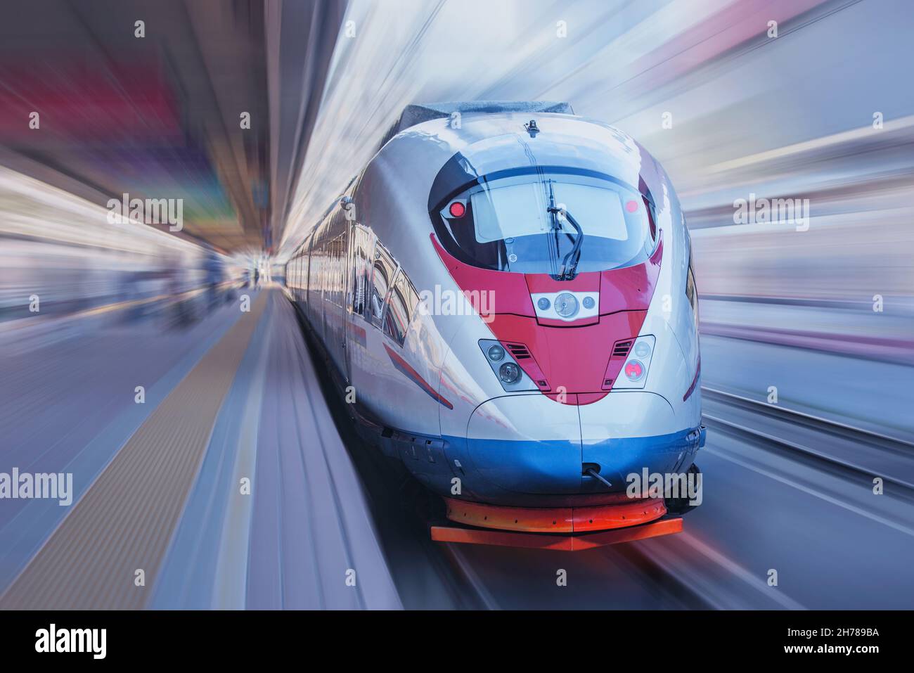 Modern high-speed train moves fast along the platform Stock Photo - Alamy