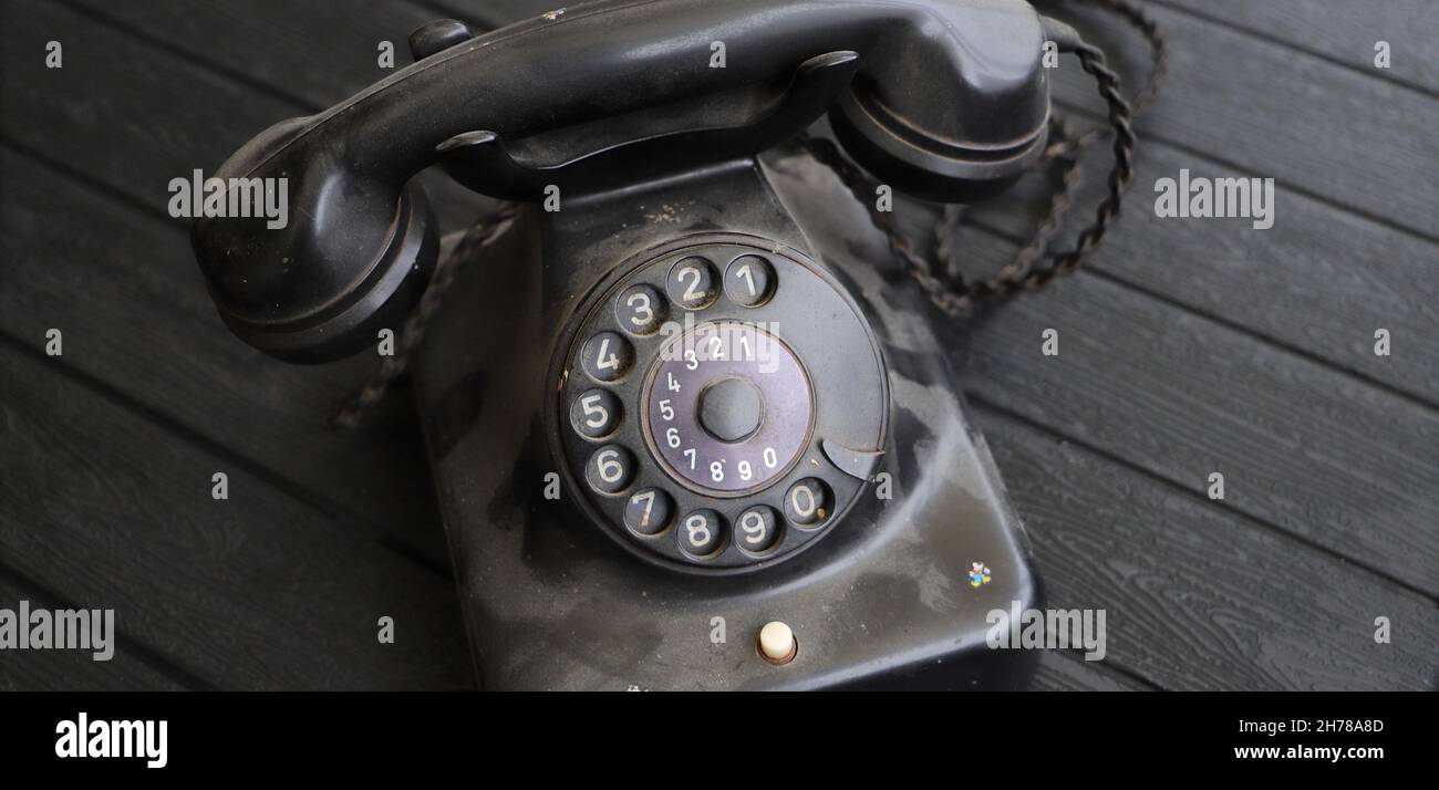 an old, dusty black rotary phone Stock Photo - Alamy