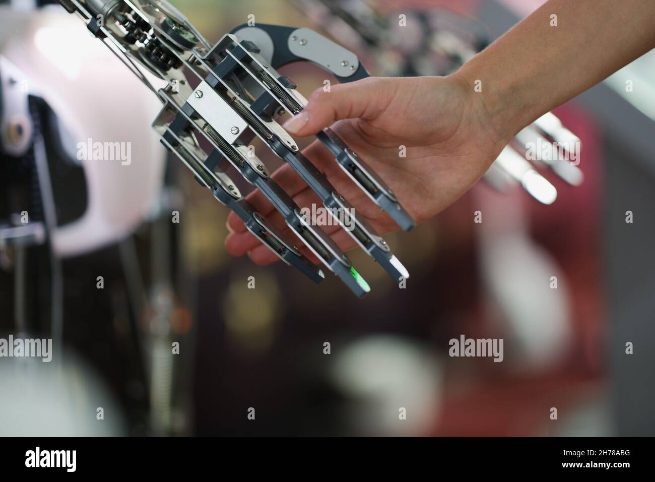 Female hand holding a cyborg metal hand Stock Photo - Alamy