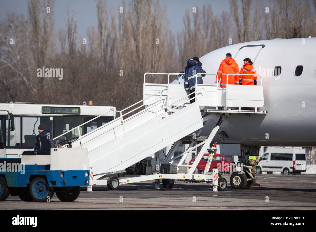 Passenger plane at airport in winter. Landing passengers in airliner in ...