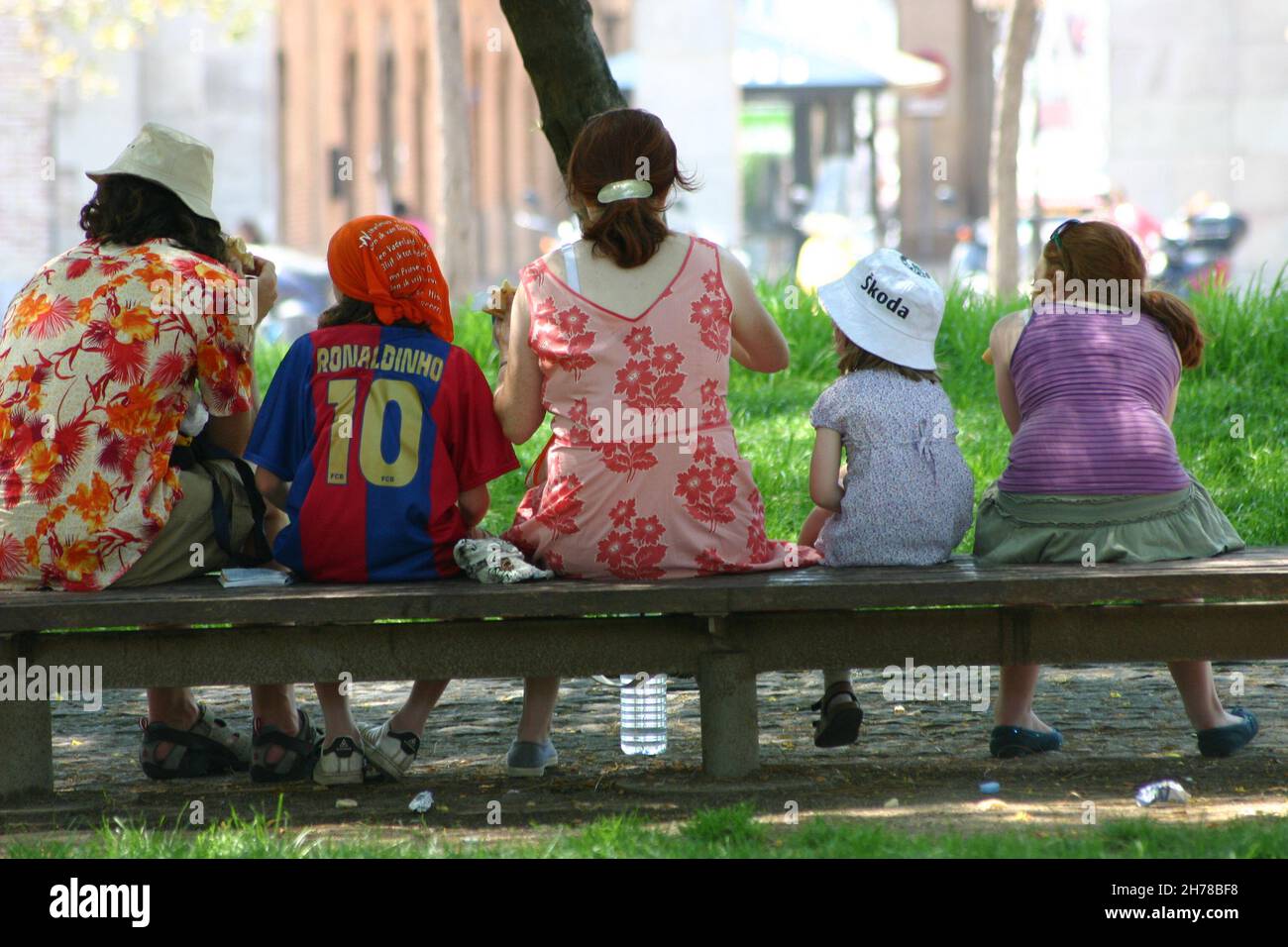 Several generations sitting on one bench Stock Photo - Alamy
