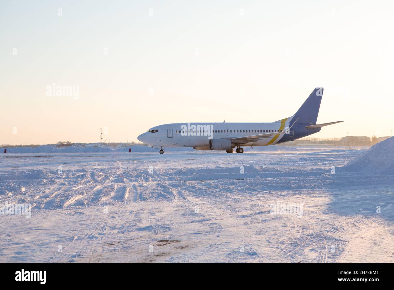 Airliner on runway in blizzard. Aircraft during taxiing on landing ...