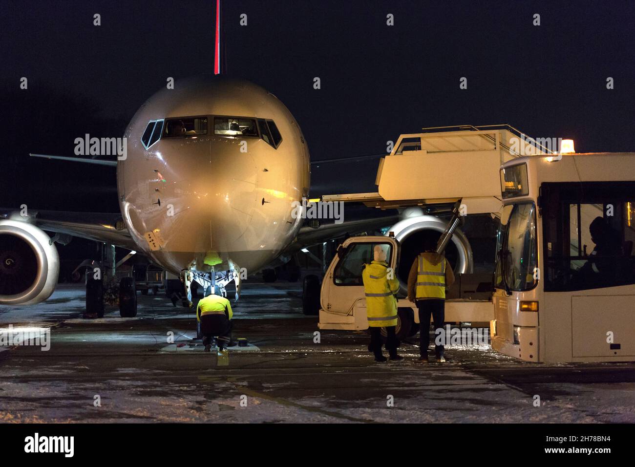Passenger aircraft at night at airport. Airplane in winter at night at ...