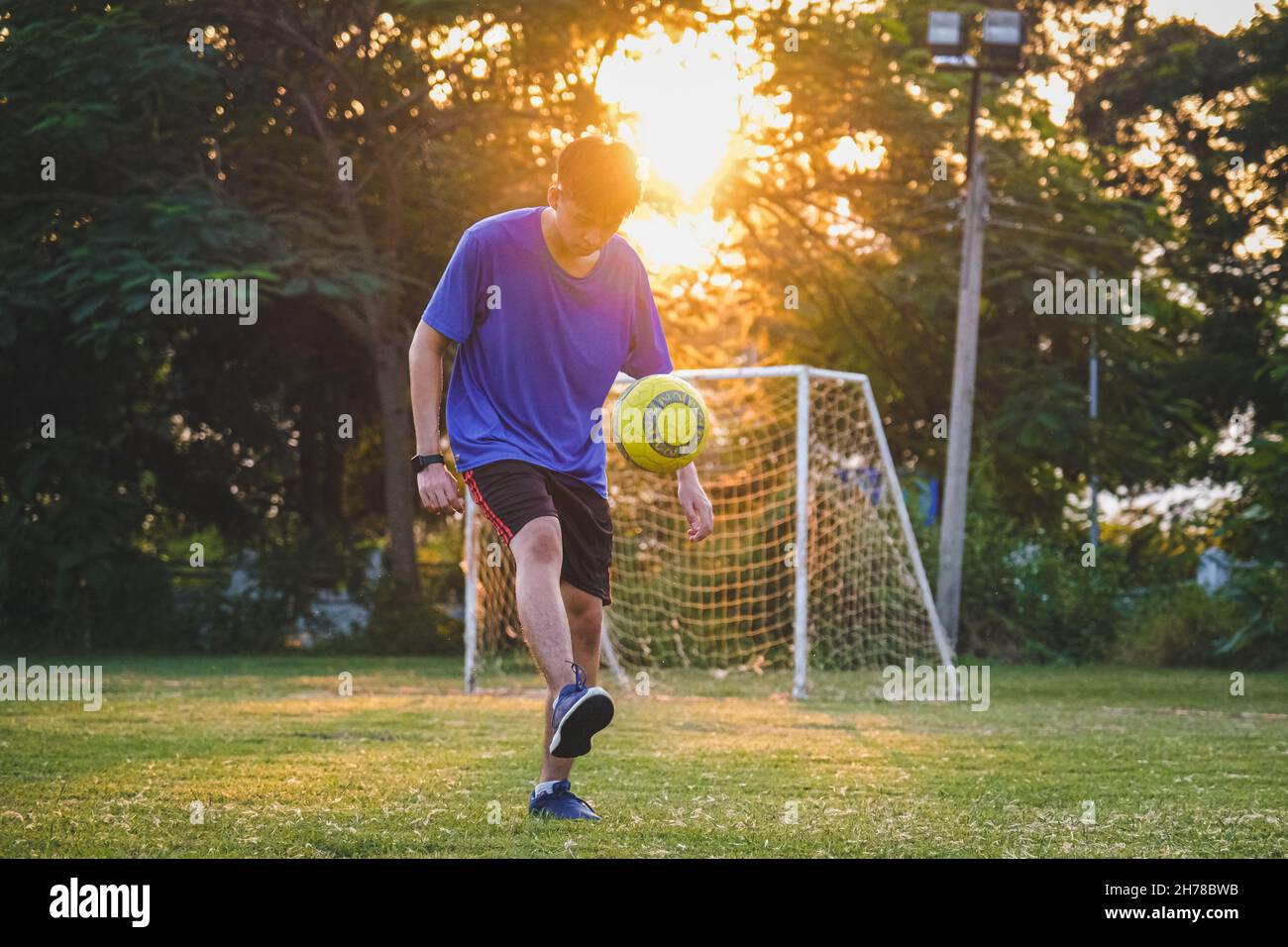 Football player training in soccer field. Young footballer practicing ...