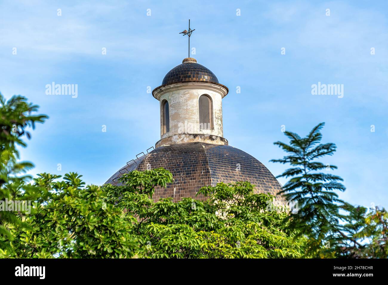 Cupola with a Christian cross on top seen in a colonial style Catholic ...