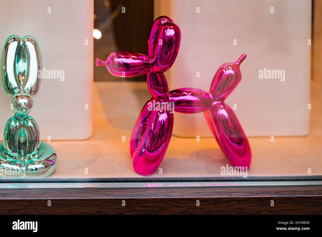 Pink balloons glass dog and green balloons rabbit statue behind the ...