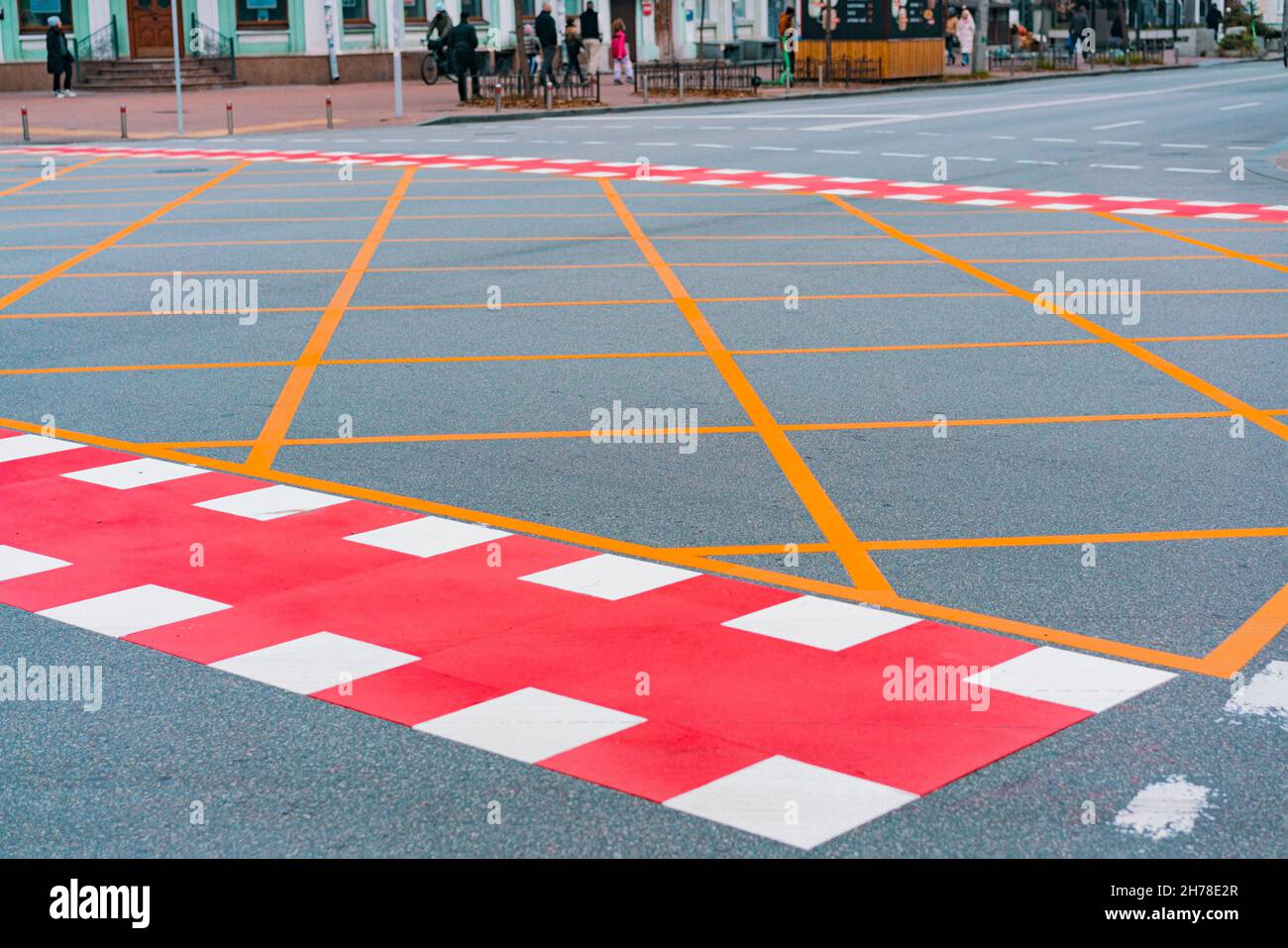 Intersection with yellow markings and red and white lanes for bicycles ...