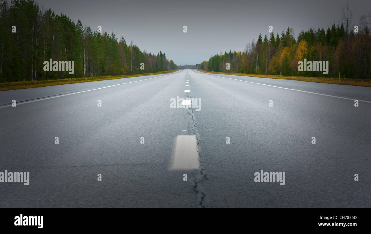 A black asphalt road with white dividing lines Stock Photo - Alamy