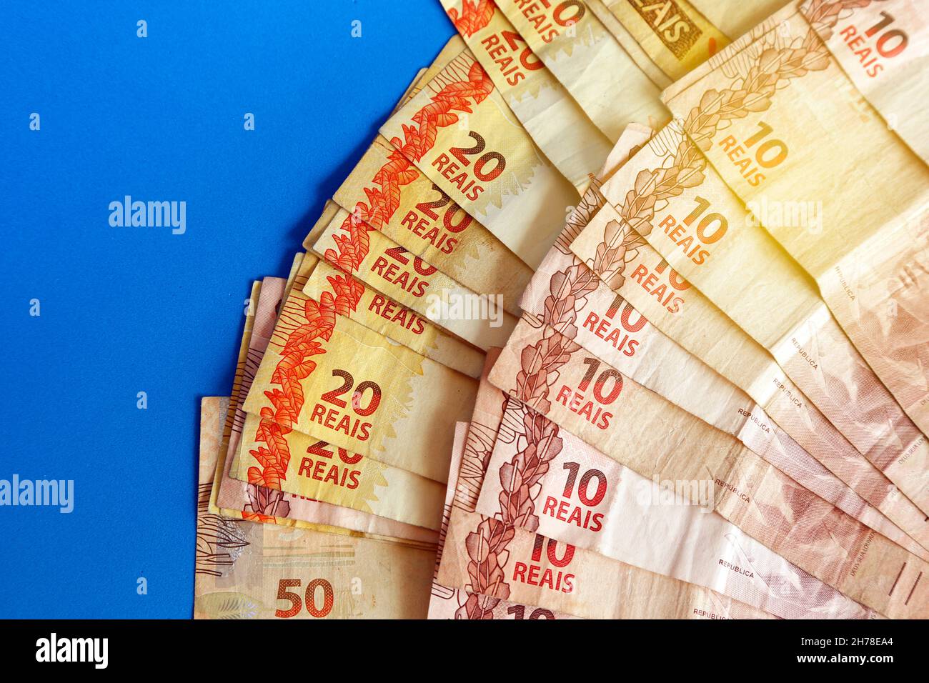 Brazil money stacked on blue surface - several real bills Stock Photo ...