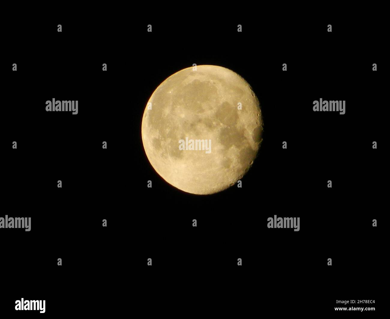 The yellow full moon isolated in the dark nighttime sky Stock Photo - Alamy