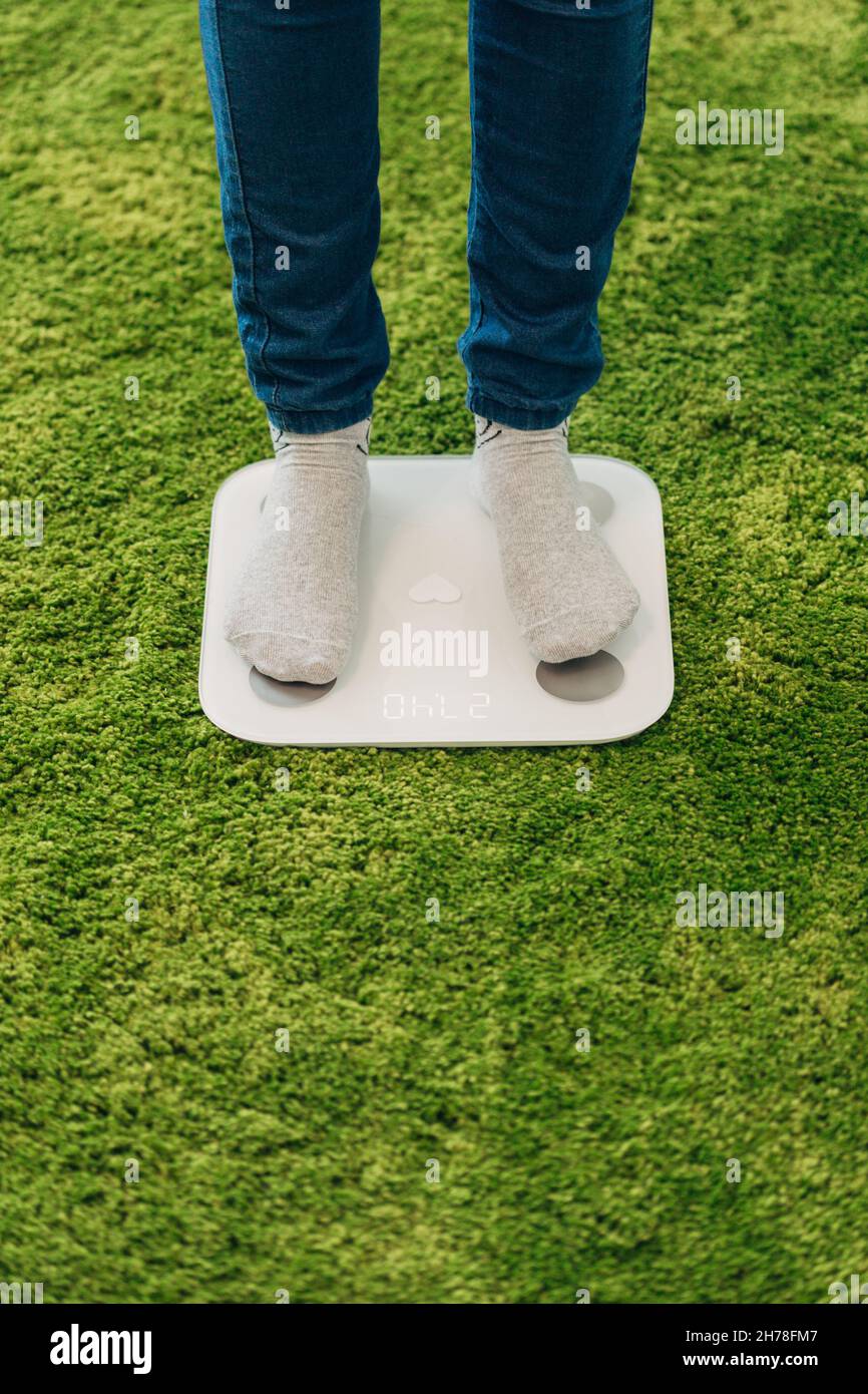 Girl Measures Weight on the Smart Scales Stock Photo - Alamy