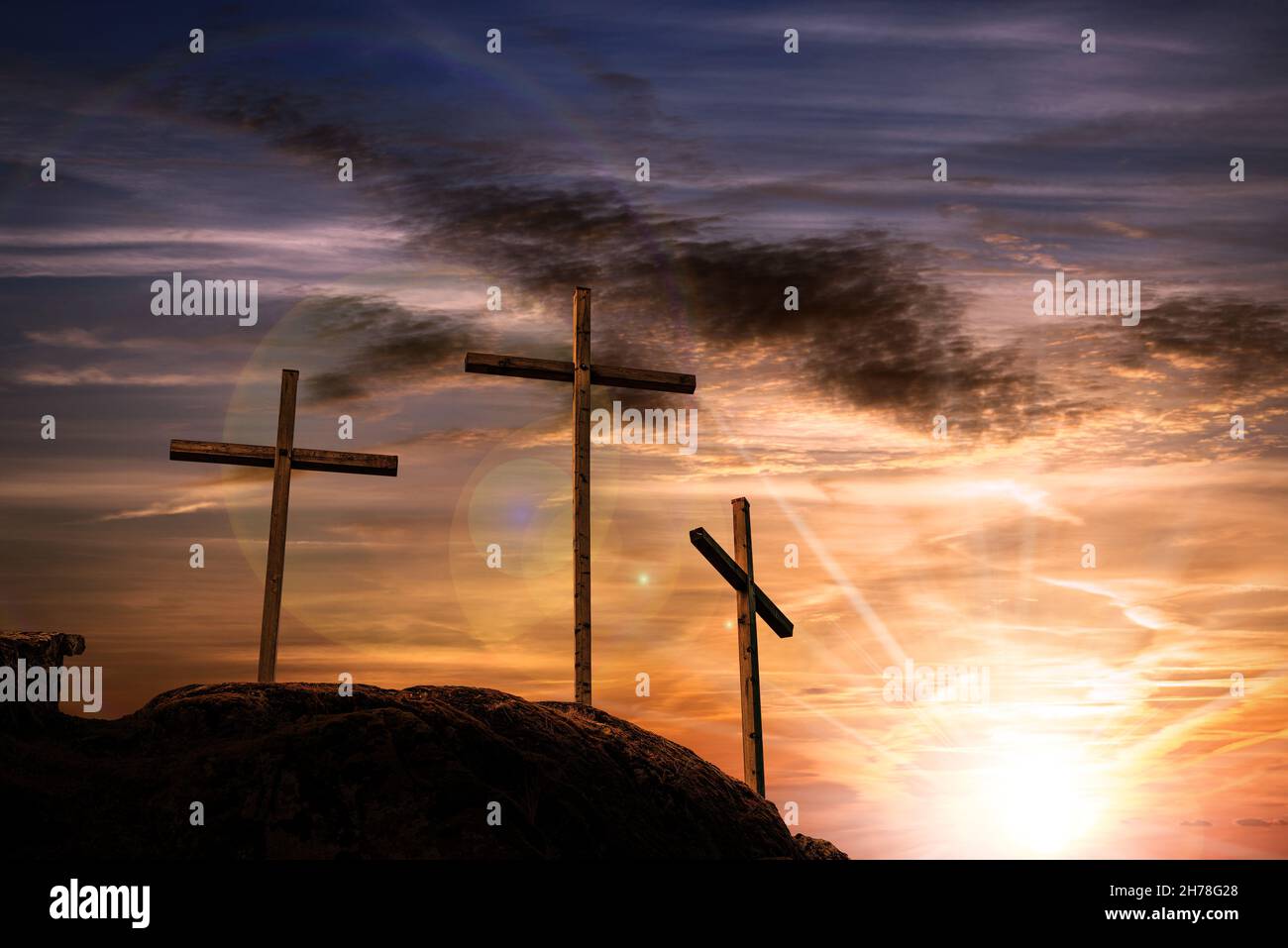 Silhouette of three wooden crosses above the hill with dramatic sky and ...