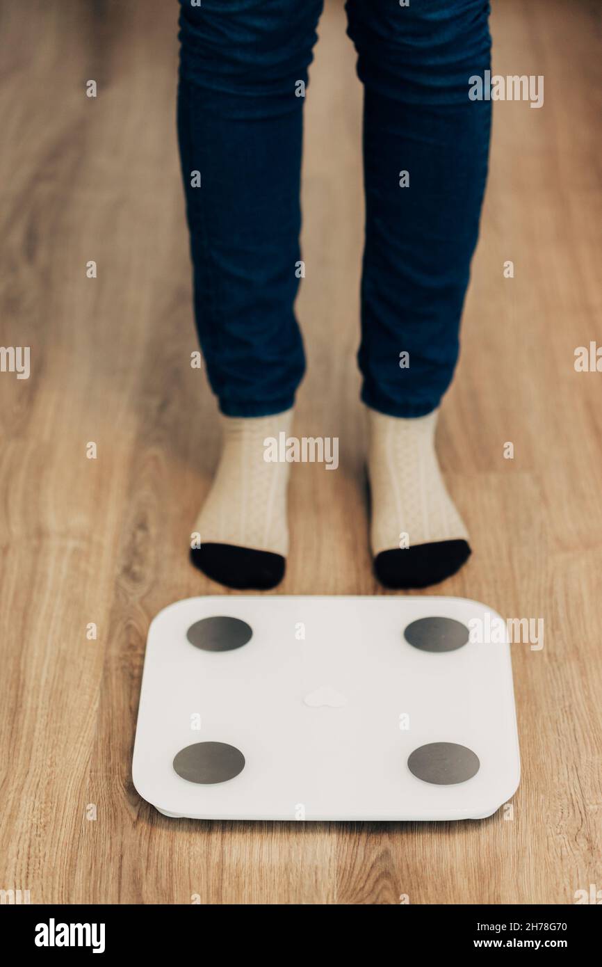 Girl Measures Weight on Smart Scales. Modern Electronic Device Stock ...