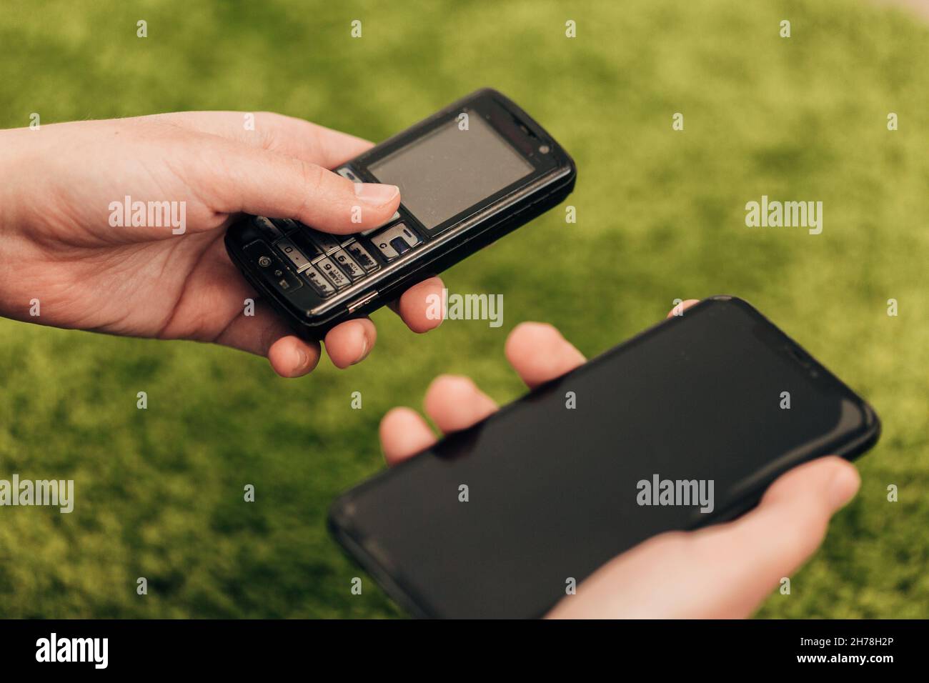 The Human Hand Choosing Phone That Lies Near New Smartphones Stock ...