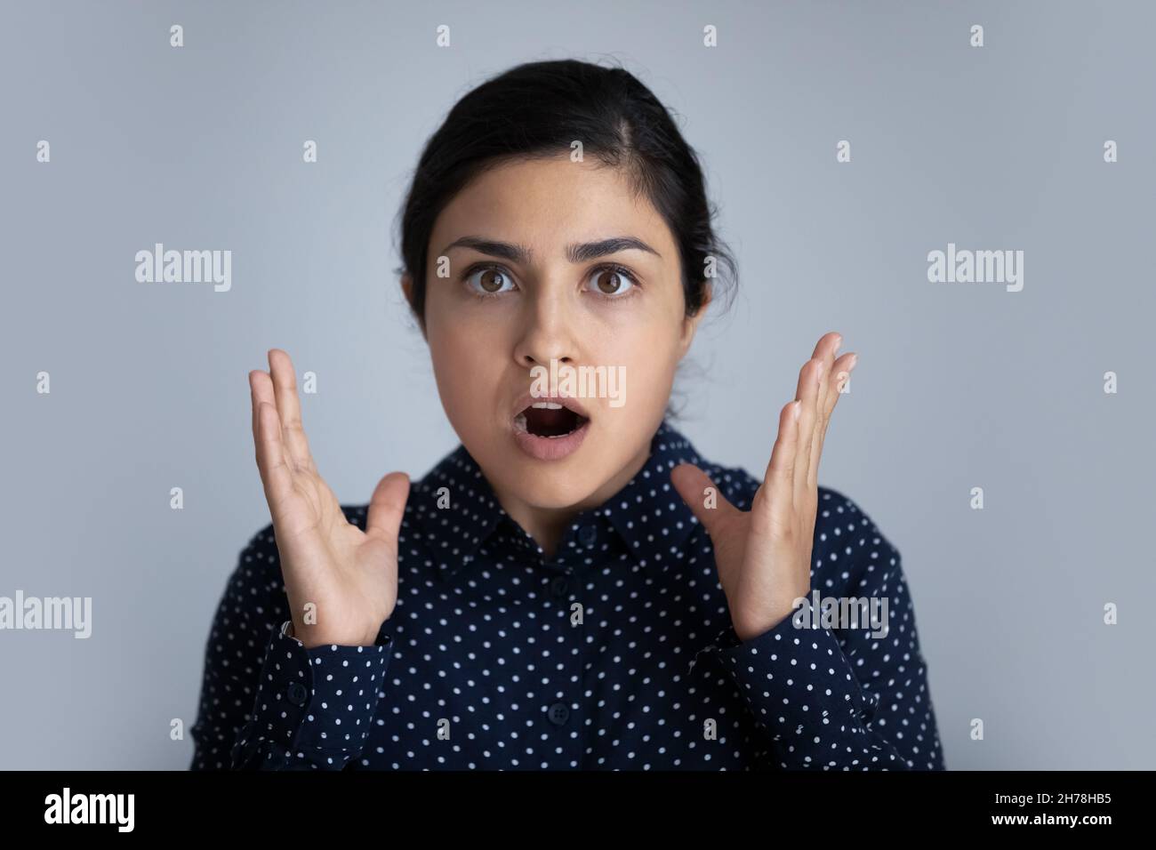 Stressed surprised young Indian woman looking at camera Stock Photo - Alamy