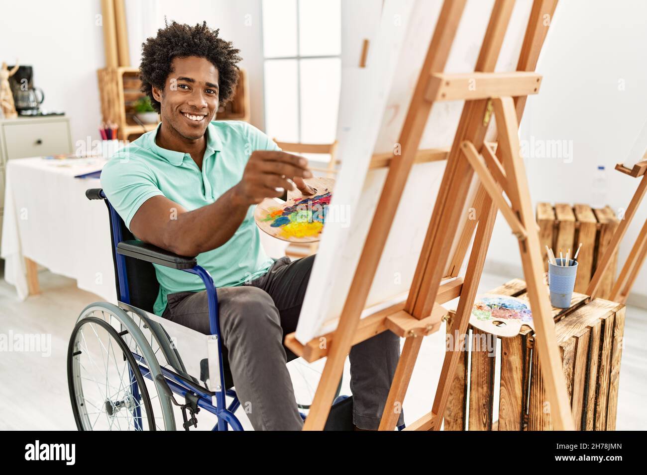Young african american disabled artist man sitting on wheelchair ...