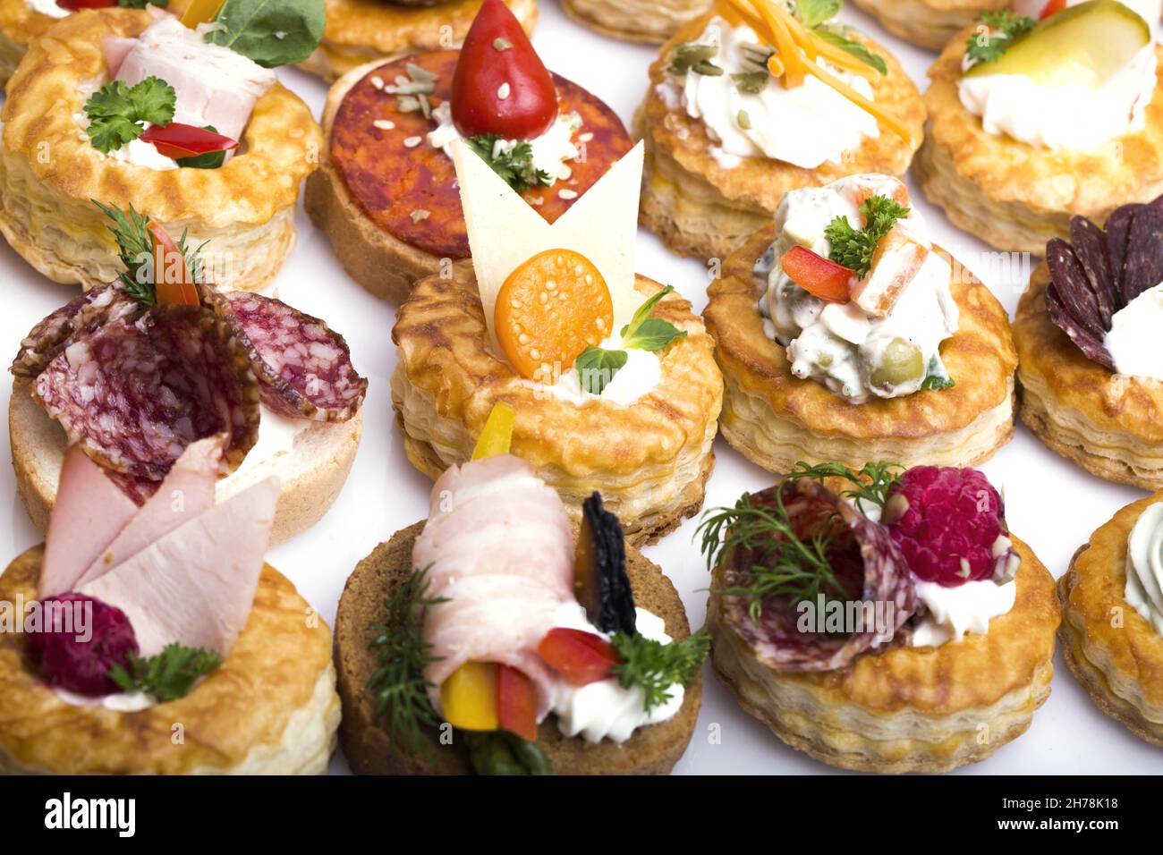 A top view of canapes with different ingredients on a white background ...