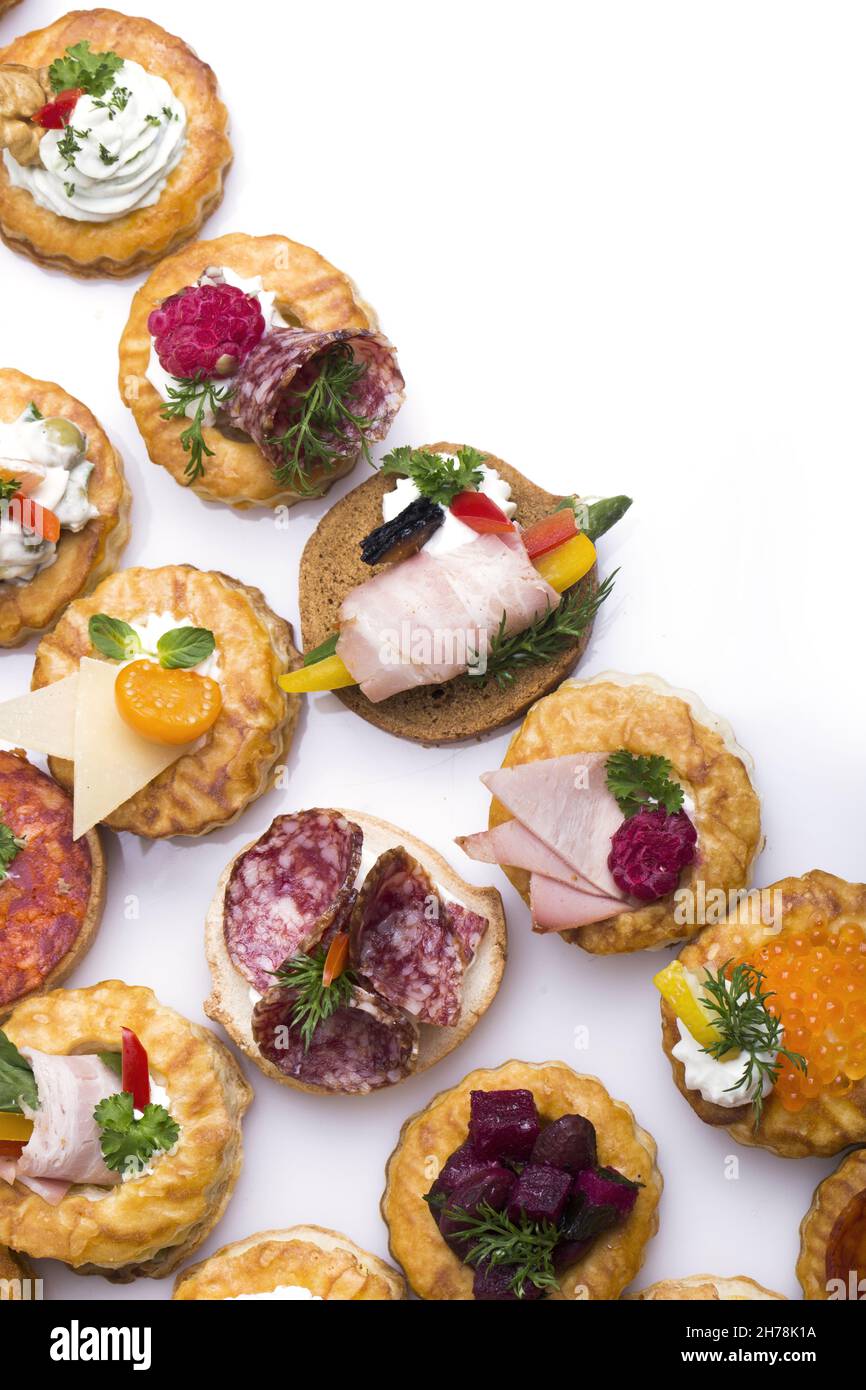 A top view of canapes with different ingredients on a white background ...