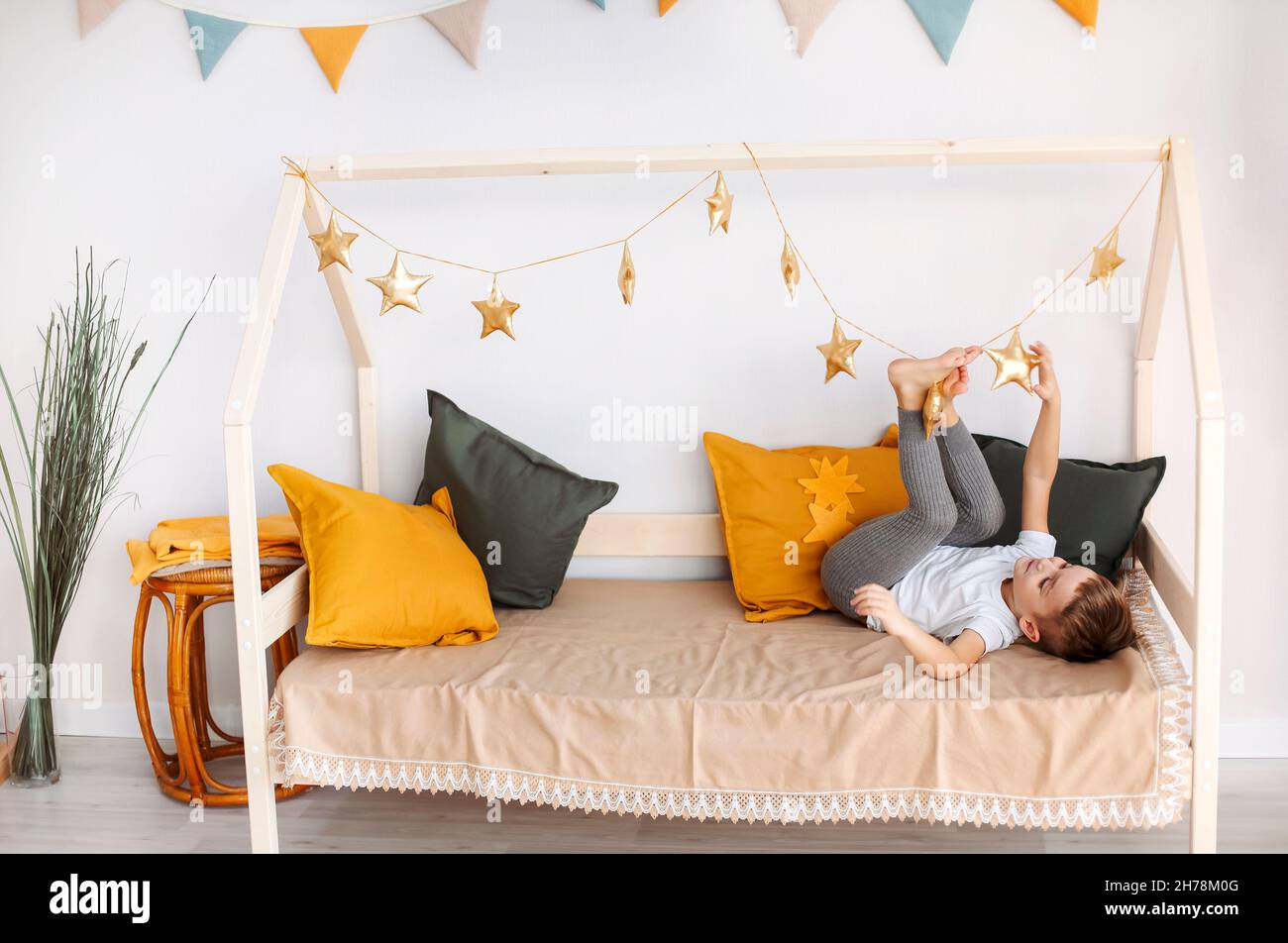 Active playful little boy child playing and having fun on bed in his ...