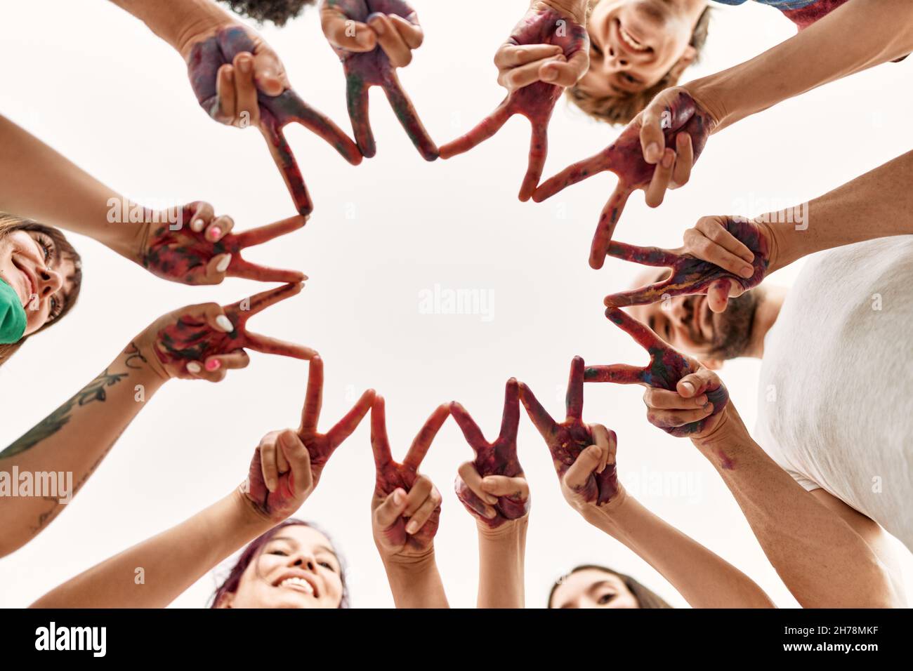 Group of young friends doing victory sign with fingers and hands ...