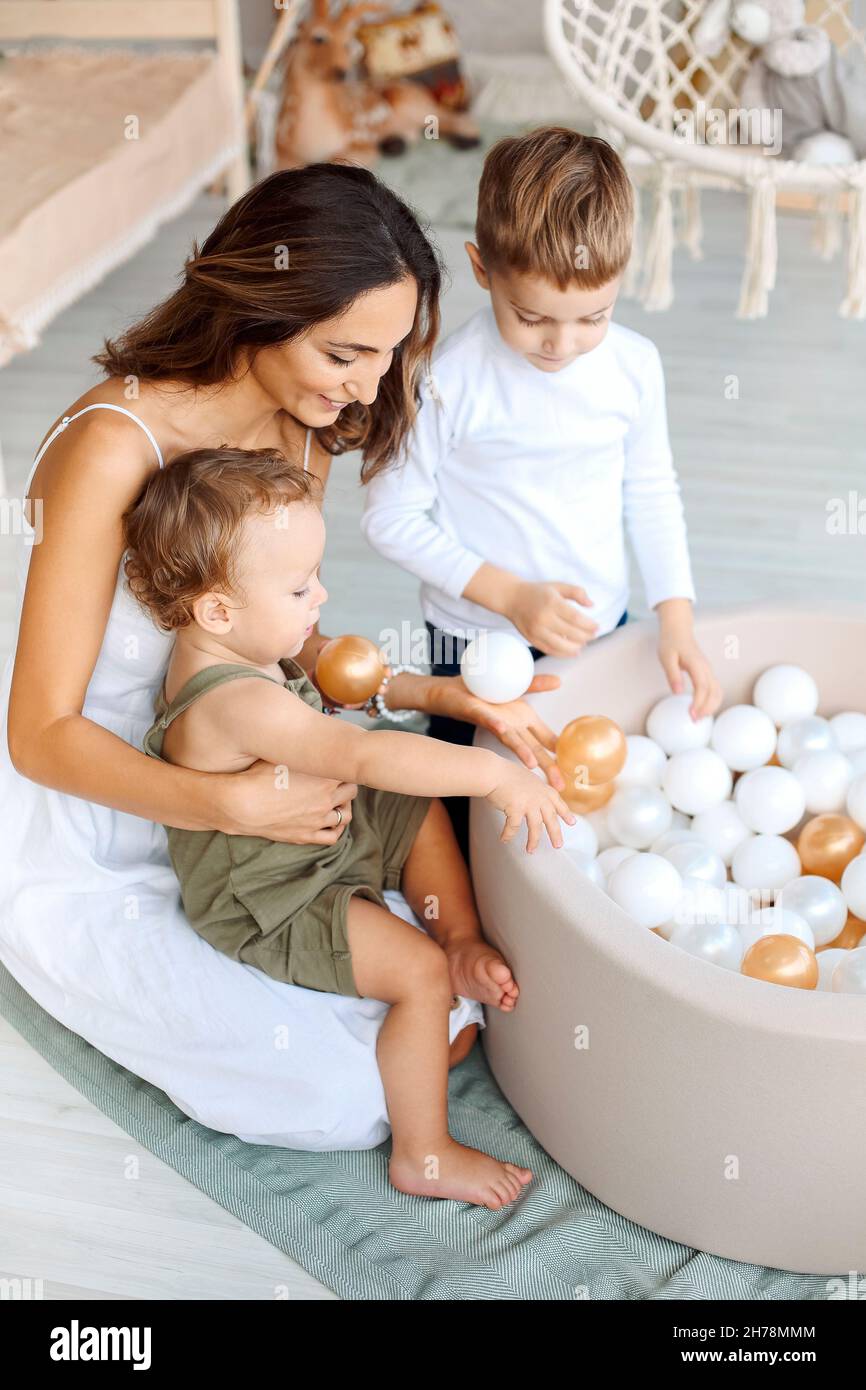 Mum holding two kids hi-res stock photography and images - Alamy