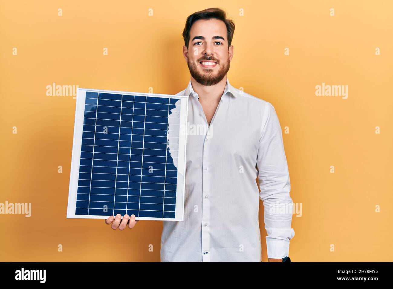 Handsome caucasian man with beard holding photovoltaic solar panel ...