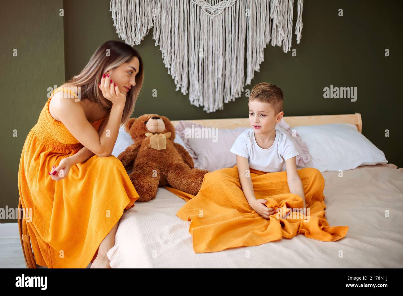 Bedtime Story Loving Mother Putting Son To Bed For Daytime Sleep Mom