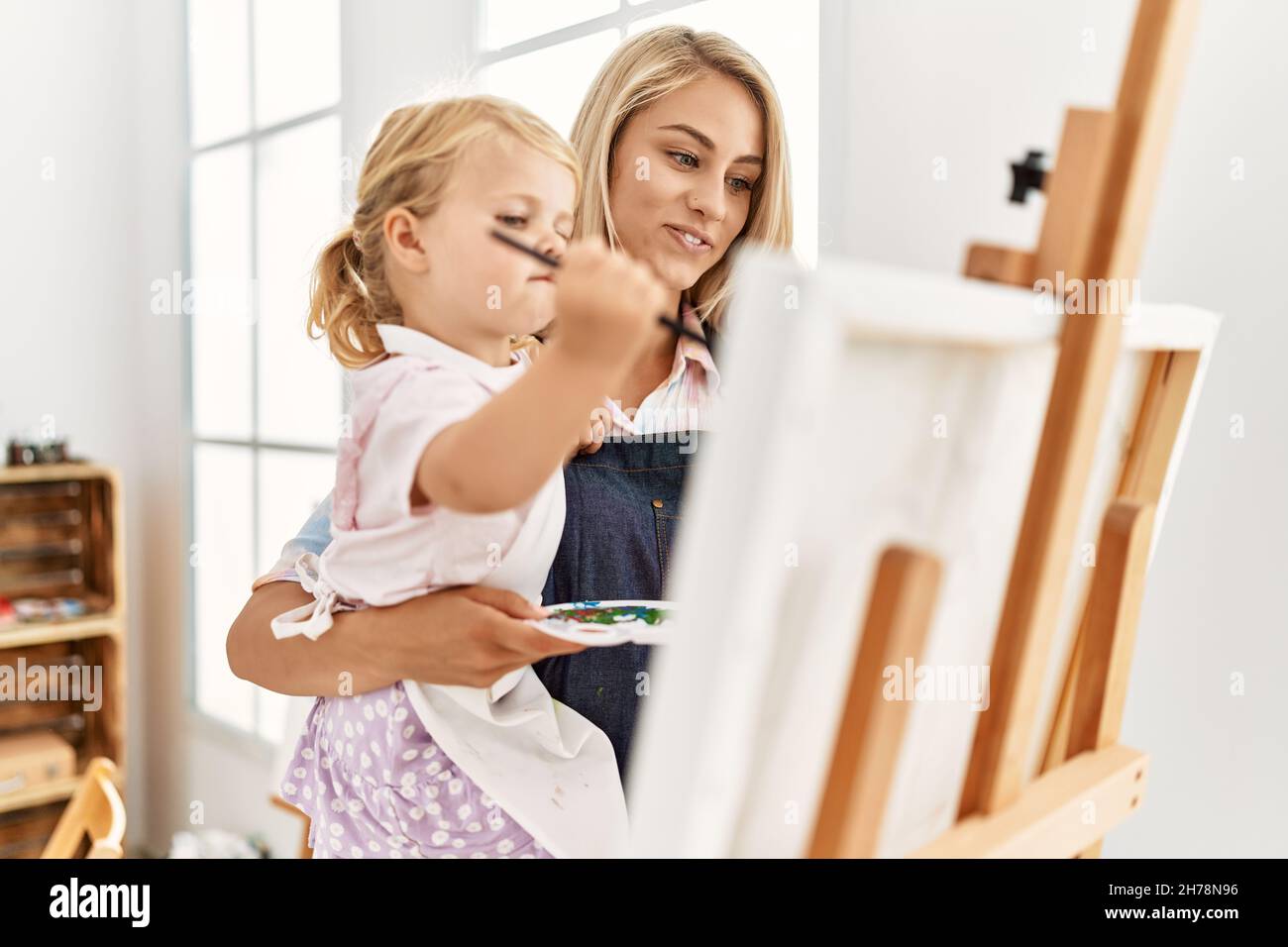 Mother and daughter smiling confident drawing at art studio Stock Photo ...