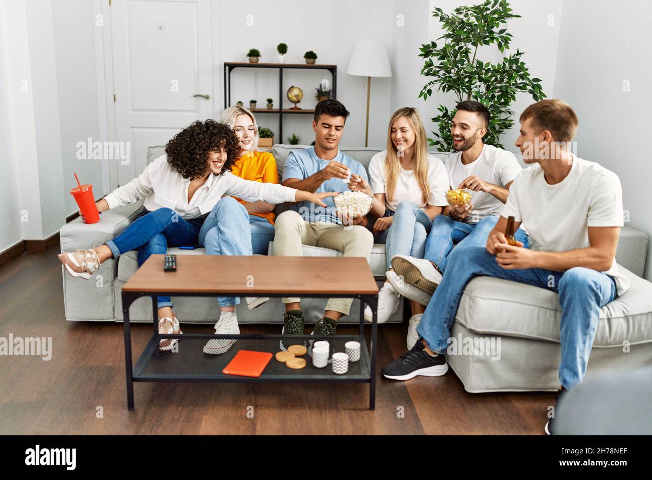 Group of young friends smiling happy watching movie at home Stock Photo ...