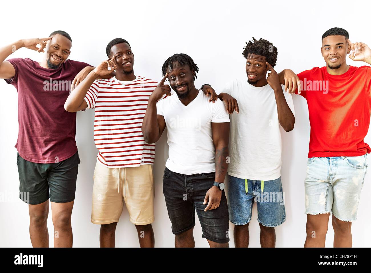 Young african group of friends standing together over isolated ...