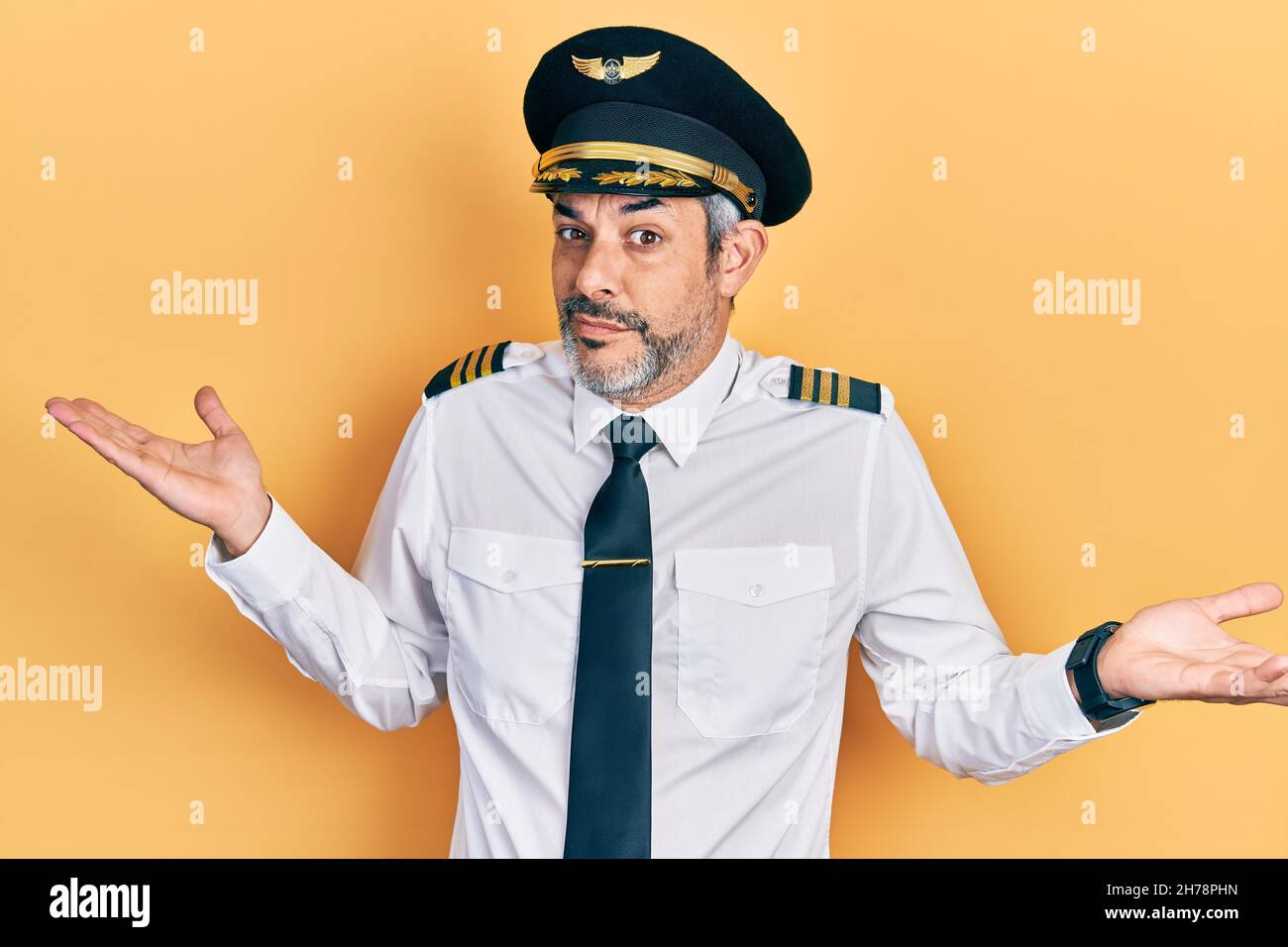 Handsome middle age man with grey hair wearing airplane pilot uniform ...